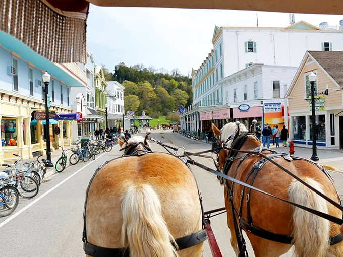 Main Street unfolds like a living postcard, where bicycles lean casually against storefronts and carriages roll past colorful awnings.