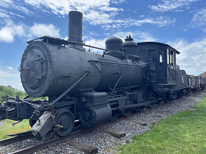 Old Number 5 sits silently on the tracks, a coal-breathing dragon now sleeping after decades hauling copper from earth's depths.