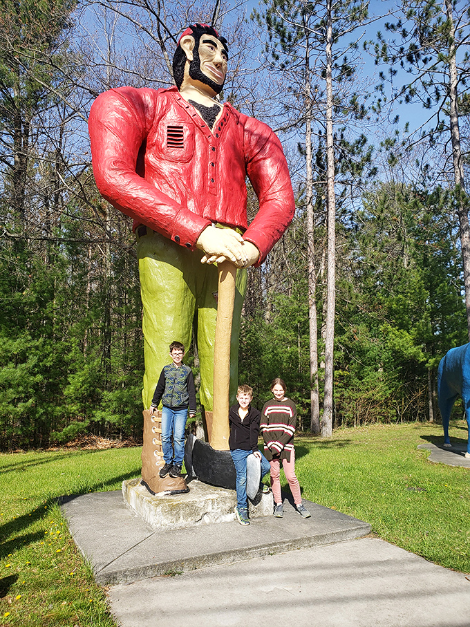 Visitors gain perspective standing beside Paul's massive boots, making even adults look like miniature figures in a giant's world.