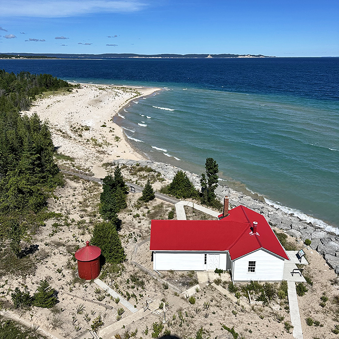 Aerial view: From above, the lighthouse compound reveals itself like a movie set&mdash;white buildings with cherry-red roofs against nature's perfect backdrop.