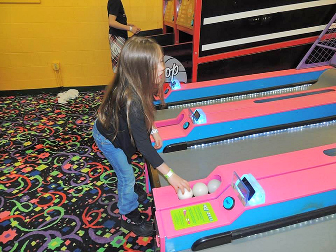 Concentration etched on young faces as tiny hands guide balls through colorful tracks &ndash; childhood joy measured in points and flashing lights.
