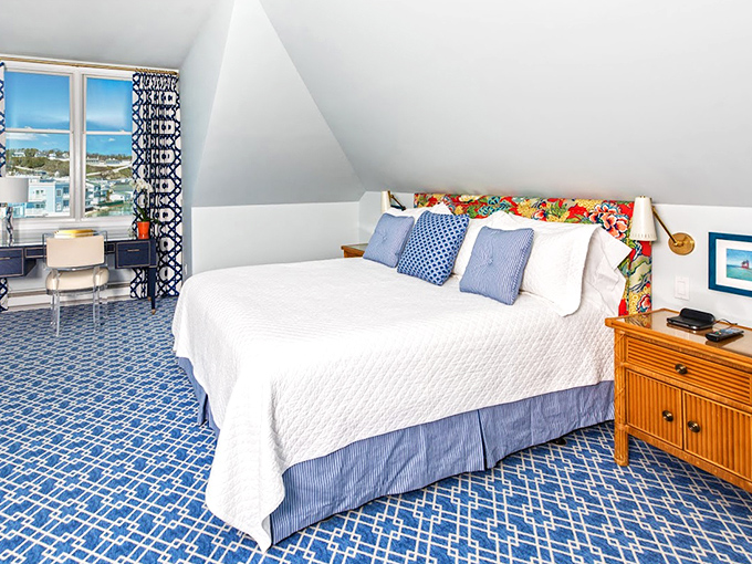 Crisp white linens meet nautical blue accents in rooms that whisper "sleep in" even to the most dedicated early risers.