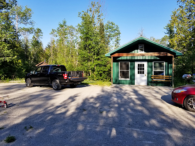 Rustic charm awaits: This unassuming green cabin serves as a gateway to wilderness adventures, standing sentinel at the park's entrance.