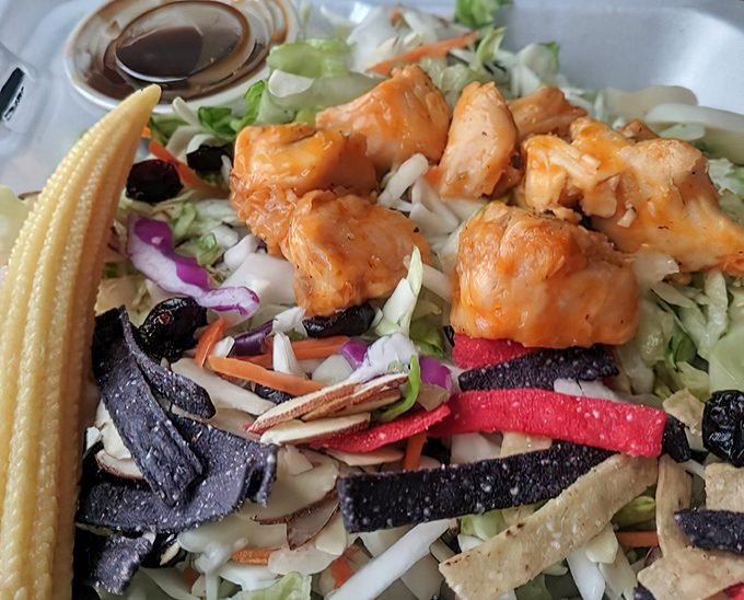 This isn't just any chicken salad &ndash; tender chunks of meat nestled among crisp vegetables with tortilla strips adding unexpected crunch.