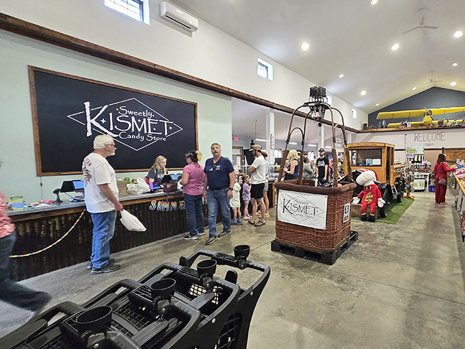 The Kismet counter area buzzes with activity as candy enthusiasts gather to select their sugary treasures, beneath the watchful eye of the store's vintage signage.
