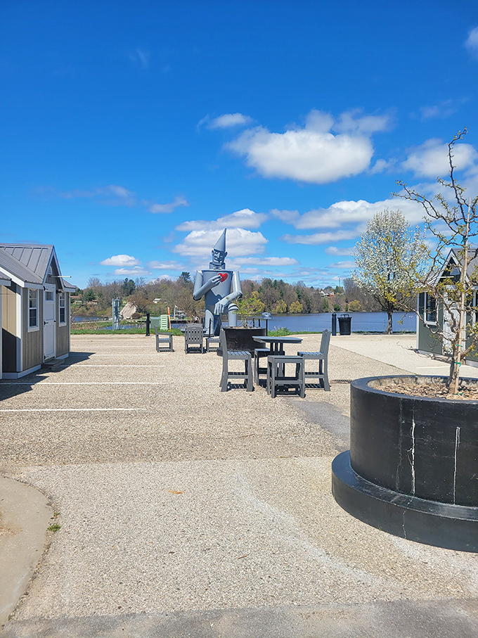 The Tin Man stands sentinel in a peaceful lakeside plaza, offering visitors a perfect spot for contemplation and photos.