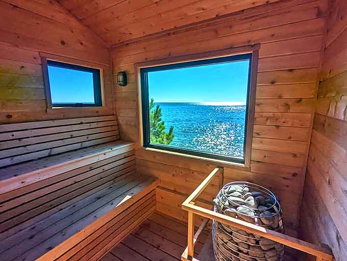 Inside the cedar-lined chamber, panoramic windows frame nature's masterpiece while benches invite you to surrender to healing heat.
