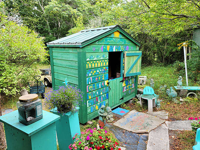 This whimsical green playhouse in the garden looks like it escaped from a children's storybook, complete with colorful hand-painted lettering and magical vibes.