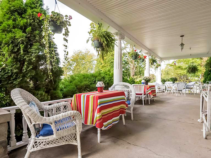 The wrap-around porch beckons with wicker seating and colorful tablecloths &ndash; Mother Nature's living room with better air circulation.