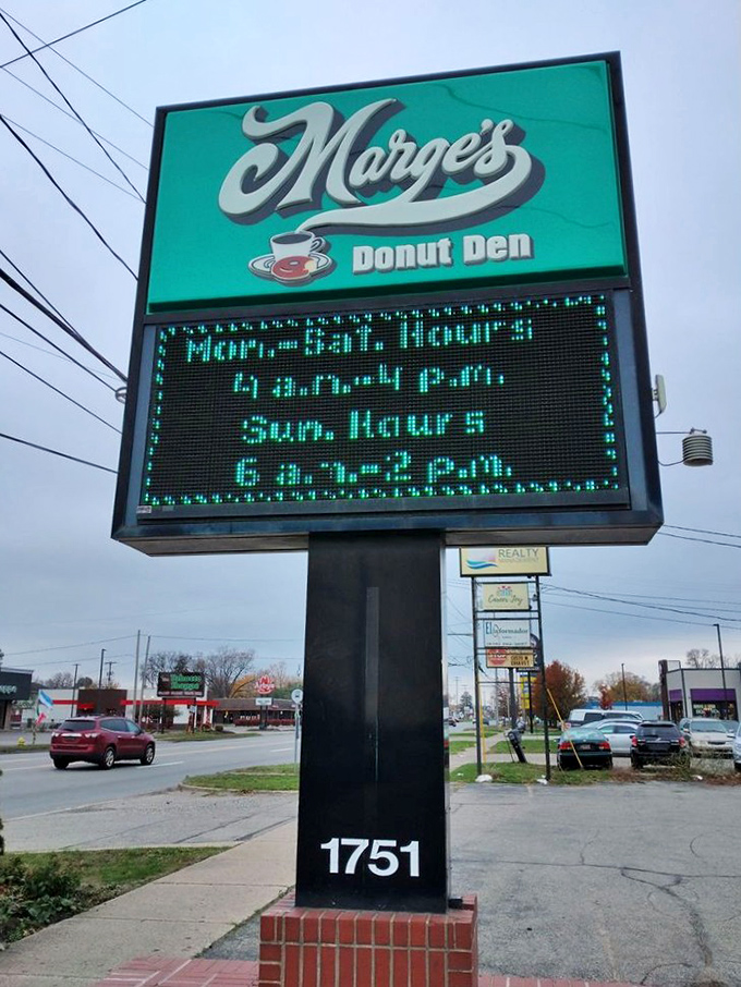 The glowing digital sign announces Marge's hours, a beacon of hope for early risers and those with sudden donut cravings.