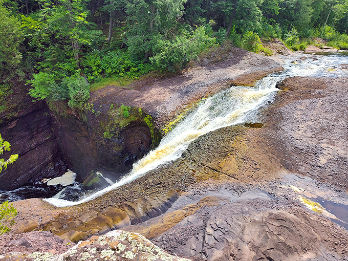 Water tumbles dramatically over rugged rock ledges, creating nature's own version of a multi-tiered fountain that would make any landscape architect jealous.