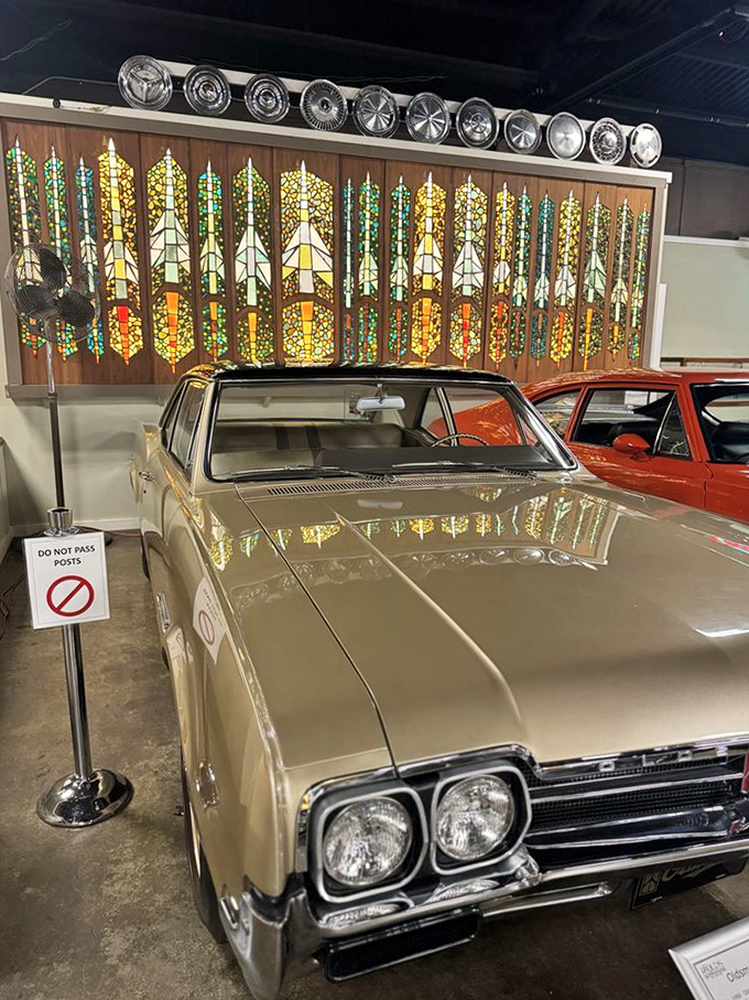 Gleaming under museum lights, this vintage beauty showcases the craftsmanship and attention to detail that defined America's golden age of automotive design.