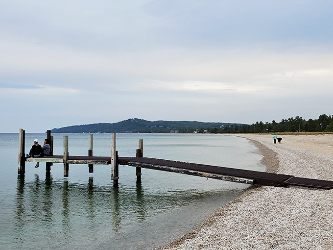 The iconic wooden dock stretches into crystal waters, offering the perfect perch for sunset watchers and deep thinkers alike.