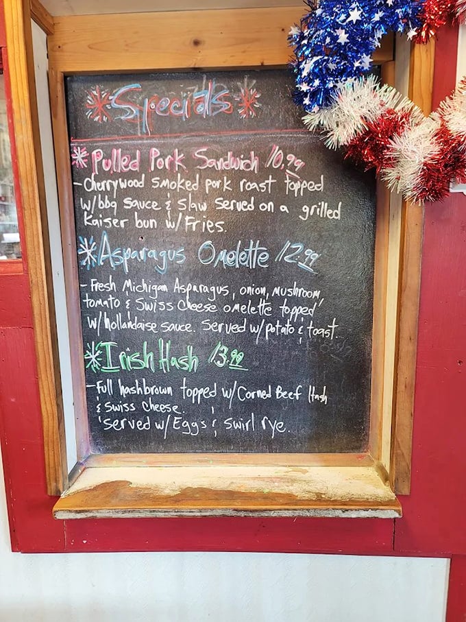 The daily specials board tempts with seasonal Michigan treasures like fresh asparagus omelets and hearty Irish hash – comfort food that speaks the universal language of delicious.