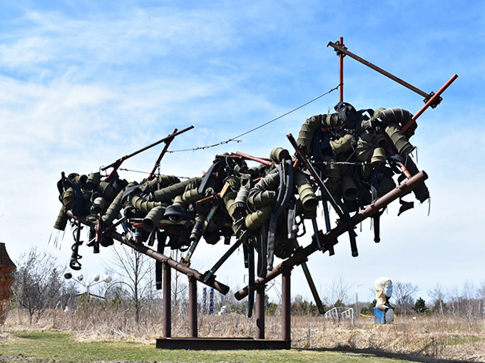 Twisted metal tubes frozen mid-dance, catching sunlight and throwing shadows that perform their own choreography throughout the day.