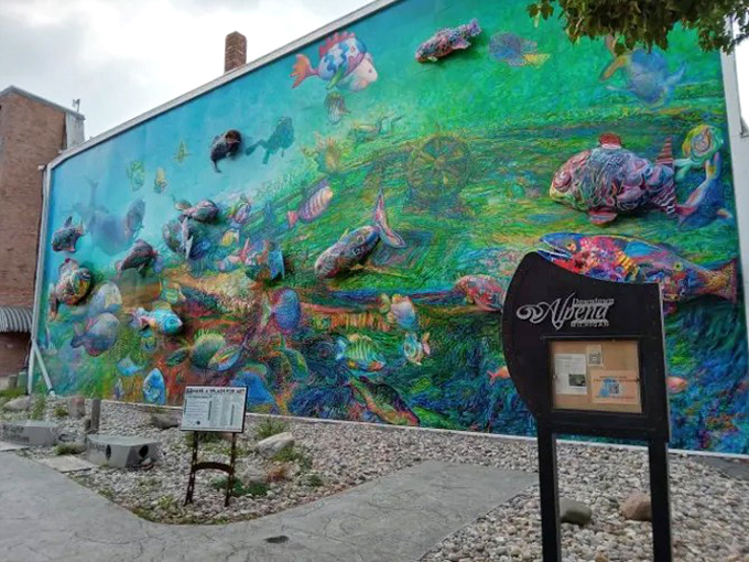 The mural commands attention on an otherwise typical Midwestern street corner, like finding an ocean at the end of your neighborhood block.