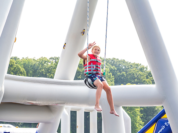 The Aquaglide Thunderdome – where childhood dreams of bouncy castles meet adult-sized adventure in a splashy showdown.