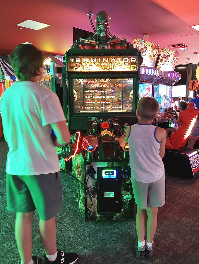 Young racers test their skills on the Terminator game, proving that virtual thrills complement the real-world racing experience.