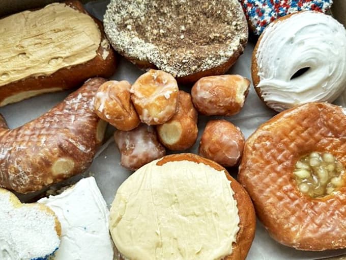 Heaven in a box! Each donut represents decades of perfection, from classic glazed to cream-filled wonders that make Monday mornings bearable.