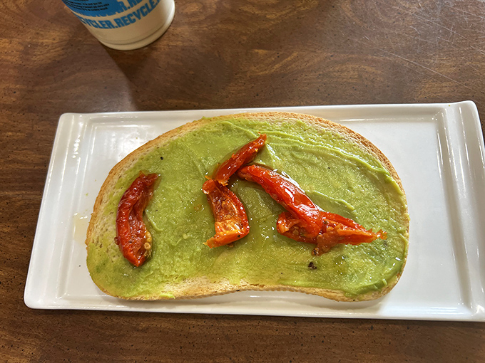 Avocado toast elevated to art form, with roasted red peppers adding color and flavor that justifies every millennial stereotype ever created.