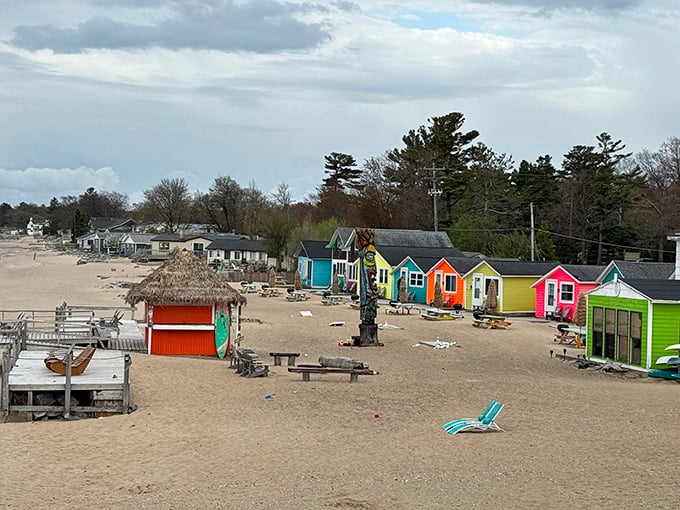 This wide view of beach chairs set in front of a rainbow row of cottages show Mai Tiki Resort's dedication to relaxation across peaceful sands.