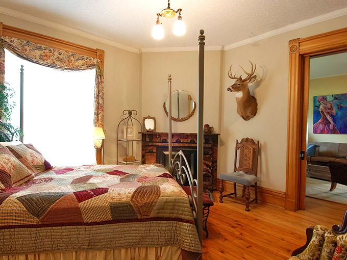 Bedroom: Cozy quilts, antique furnishings, and a mounted deer create a uniquely Michigan blend of Victorian elegance and rustic charm.
