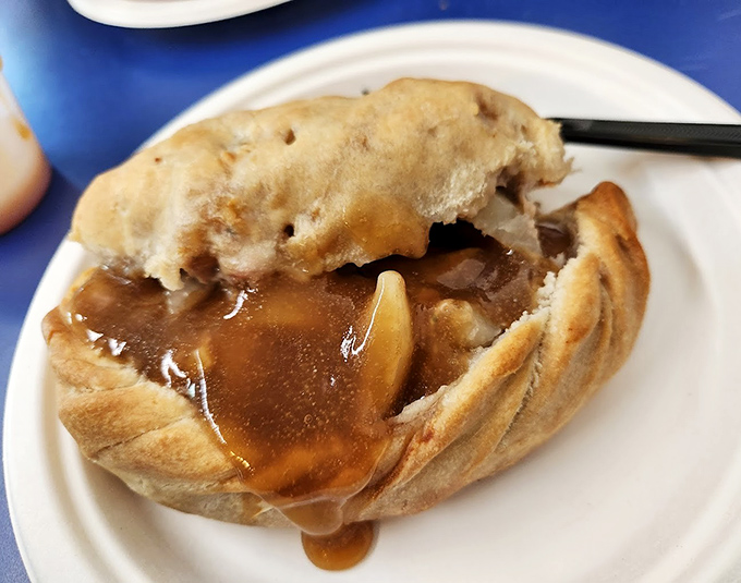 Steam rises from this golden-brown masterpiece, revealing tender beef and potatoes in perfect harmony.