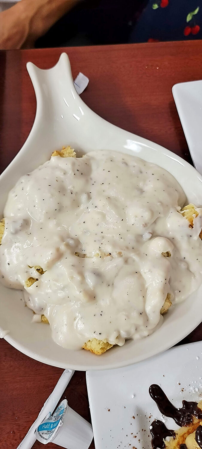 Behold the namesake dish in all its glory – a golden biscuit swimming in creamy, peppery gravy that could make a grown person weep with joy.