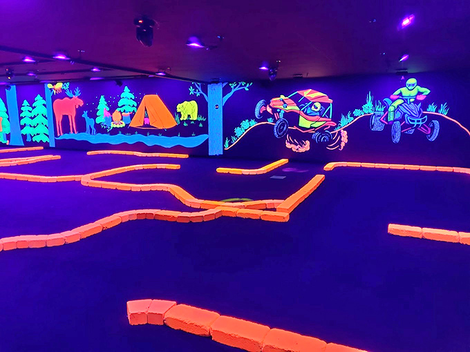 Off-road adventures await on this fluorescent fairway, where monster trucks and ATVs pop against the blacklight backdrop.