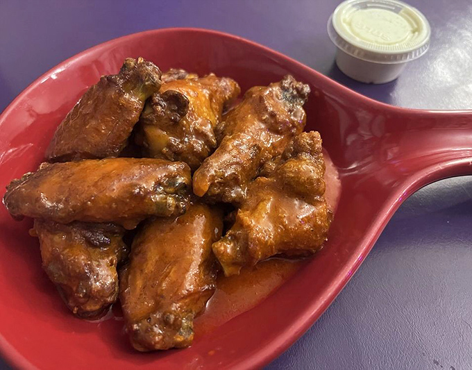 These aren't just any wings, they're the kind that make conversation stop mid-sentence, glistening with sauce and demanding your full attention.