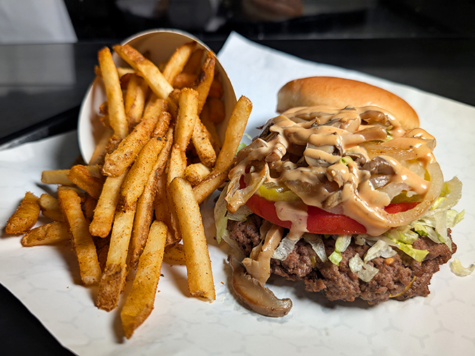 This isn't just a burger &ndash; it's a hand-crafted masterpiece with mushrooms and sauce cascading down the sides, demanding both napkins and respect.