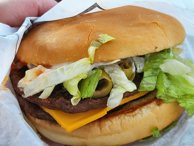 Behold the architectural marvel that is a Hot 'n Now burger, layers of fresh ingredients stacked with mathematical precision that would make engineers weep with joy.