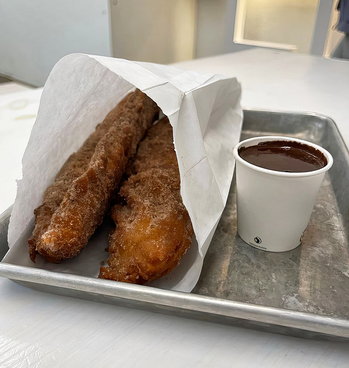 Golden-brown churros that would make your grandmother weep with joy, paired with chocolate sauce so good you'll be tempted to drink it.