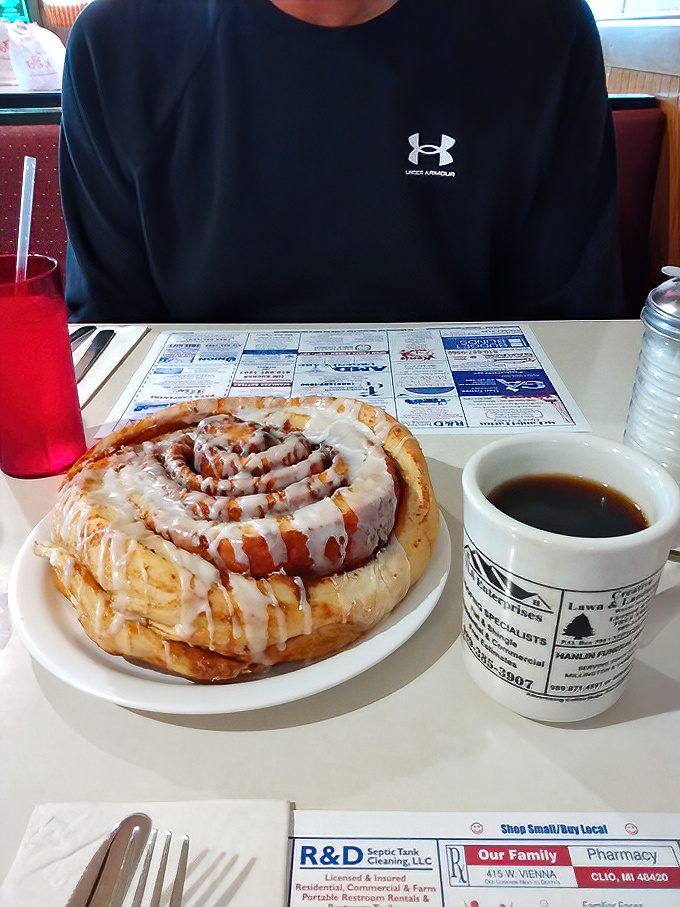 This isn't just a cinnamon roll – it's an architectural marvel of dough, cinnamon, and icing that requires both a fork and a strategic eating plan.