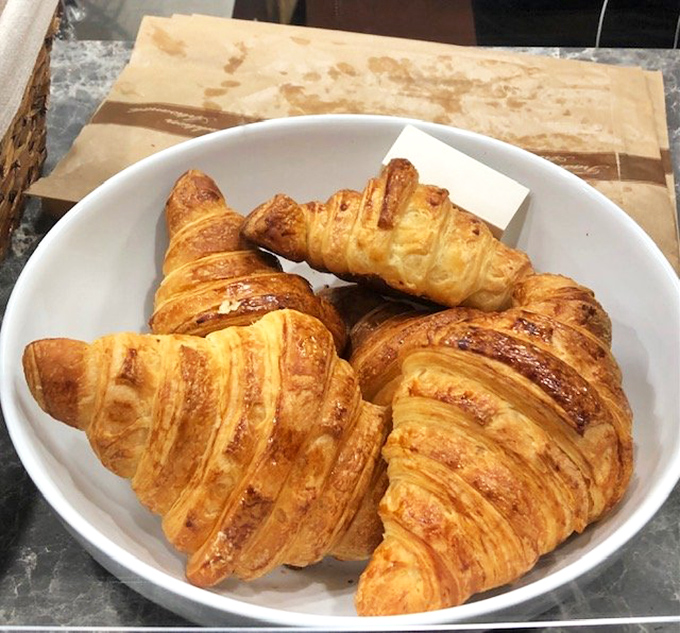 Golden, flaky croissants with their honeycomb interior reveal dozens of buttery layers &ndash; the true test of French pastry excellence.