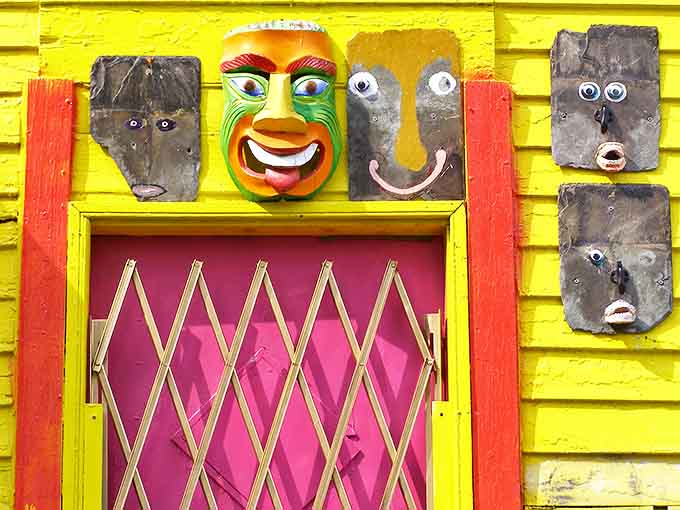 Masks with personalities galore adorn the bright yellow walls, their expressions ranging from mischievous grins to contemplative stares.