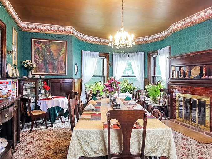 Teal walls and elegant chandelier create the perfect setting for pretending you remember which fork to use first.