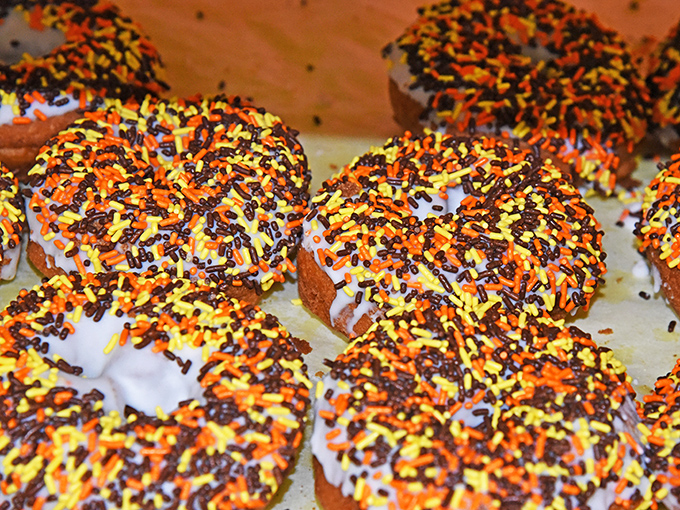 Halloween on a donut! These festive treats with orange and black sprinkles prove that simple pleasures are often the most satisfying.