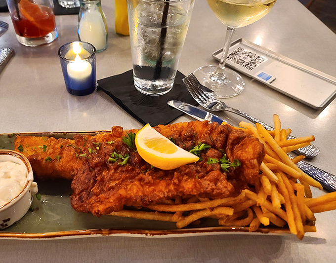 Golden-battered fish that shatters at first bite, served with crispy fries and a lemon wedge – gas station dining elevated to an art form.