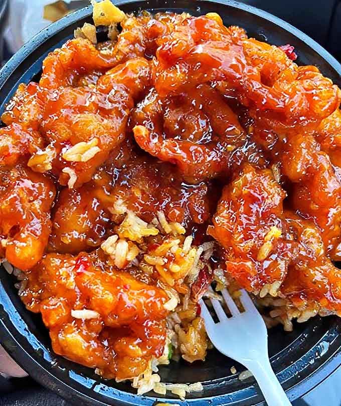 General Tso's Chicken that would make the general himself stand at attention. That glistening sauce clings to each morsel like it's afraid of being left behind!