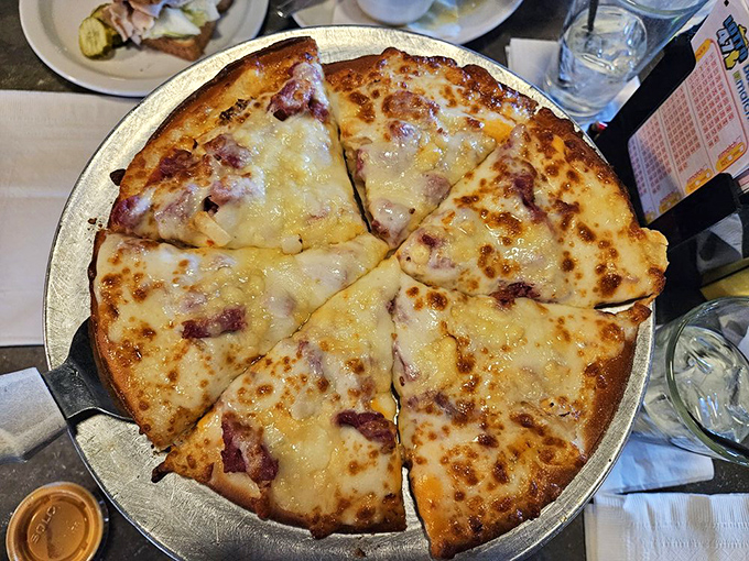 The legendary Reuben pizza transforms a classic sandwich into a circular masterpiece of corned beef, sauerkraut, and melty Swiss cheese.