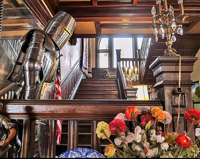 Grand Staircase: Knights in shining armor stand eternal guard beside a staircase that's witnessed over a century of footsteps&mdash;some belonging to those no longer living.