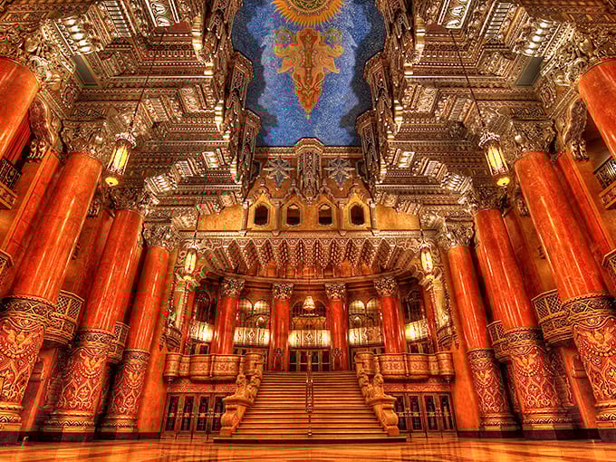 Red columns soar toward a ceiling that seems to contain its own universe &ndash; making modern theaters look like they're not even trying.