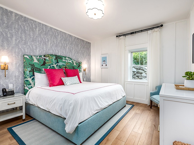 Guest Bedroom: A tropical-inspired headboard plays against soft gray wallpaper, creating a bedroom retreat that's both whimsical and supremely comfortable.