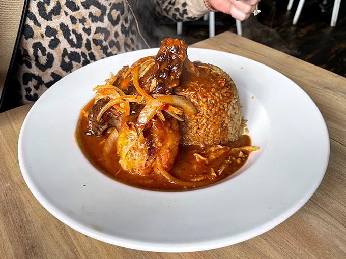 Jerk chicken that means business! Tender meat swimming in rich sauce alongside perfectly cooked rice &ndash; this plate doesn't mess around with flavor.