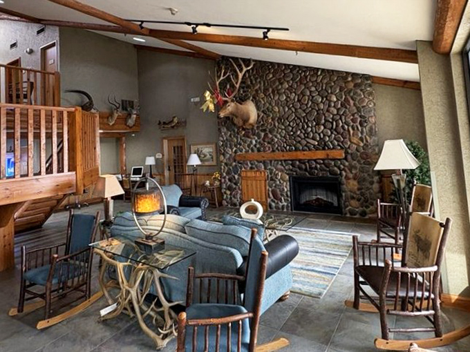 The rustic lodge-inspired lobby welcomes guests with stone fireplace and comfortable seating, a cozy contrast to the tropical water park.