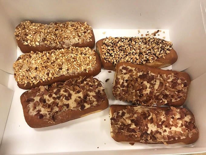 Long Johns lined up like delicious soldiers, their toppings glistening under the bakery lights – resistance is absolutely futile.
