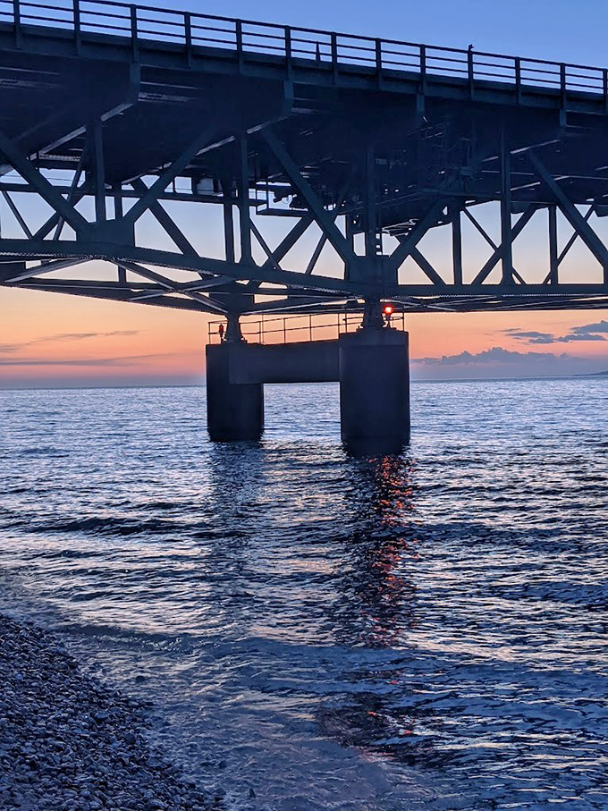 Sunset paints the bridge's underbelly in dramatic silhouette, showcasing the elegant engineering that allows it to withstand brutal straits weather.