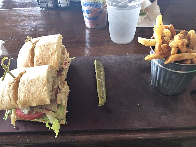 This isn't just lunch &ndash; it's edible sunshine. The Mahi sandwich arrives with golden fries, a pickle spear standing at attention like a delicious exclamation point.