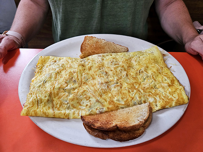 Golden perfection on a plate &ndash; this omelet stretches from edge to edge, a testament to the "bigger is better" philosophy of UP dining.